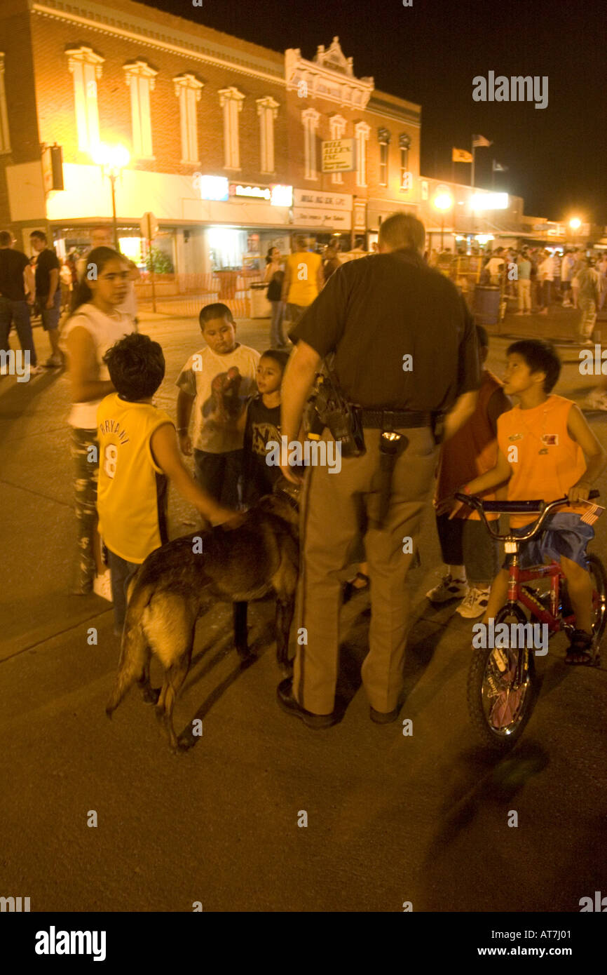 Children with police dog late at night during street dance. Saline ...