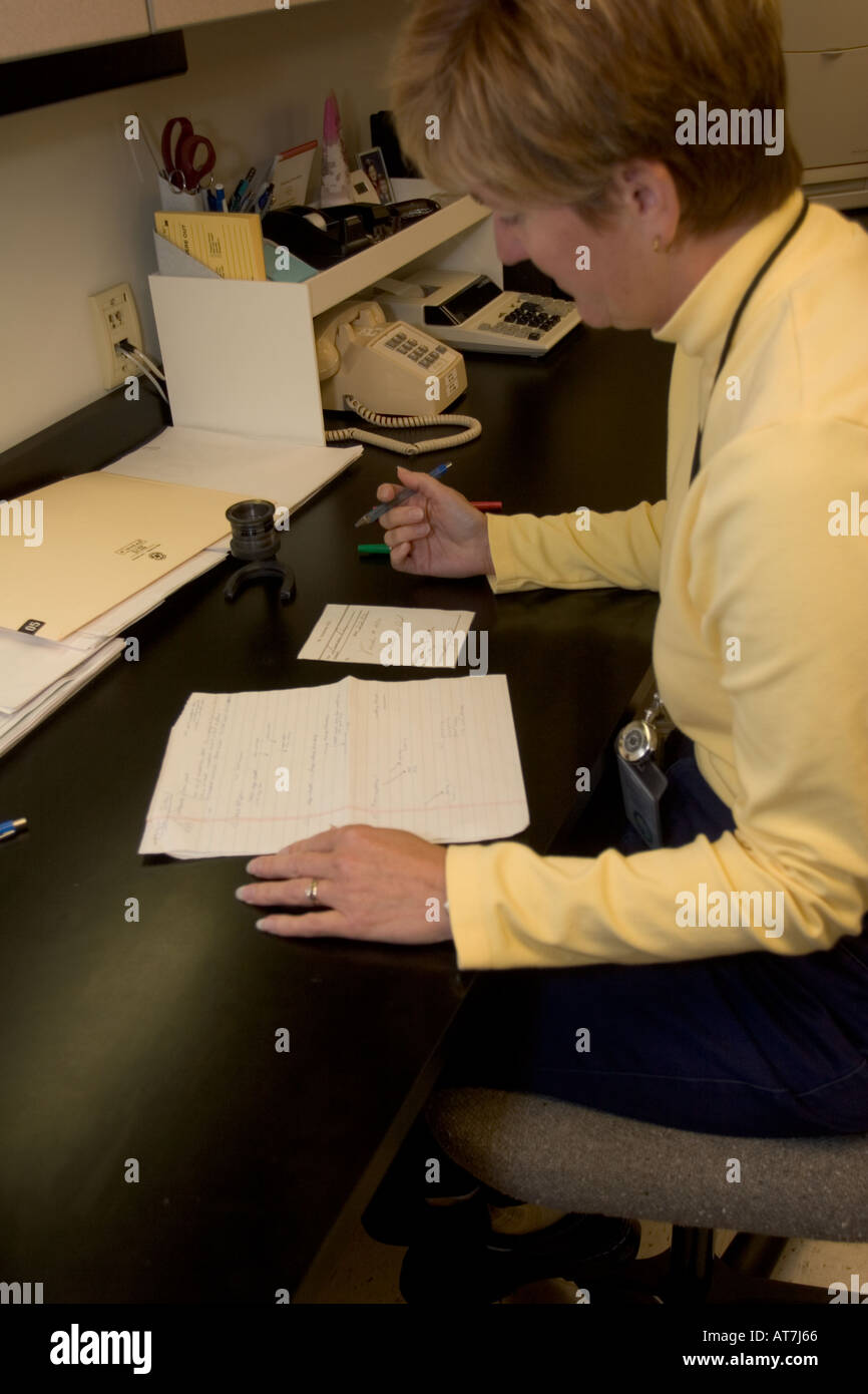 Forensic handwriting expert is comparing two handwriting samples side ...