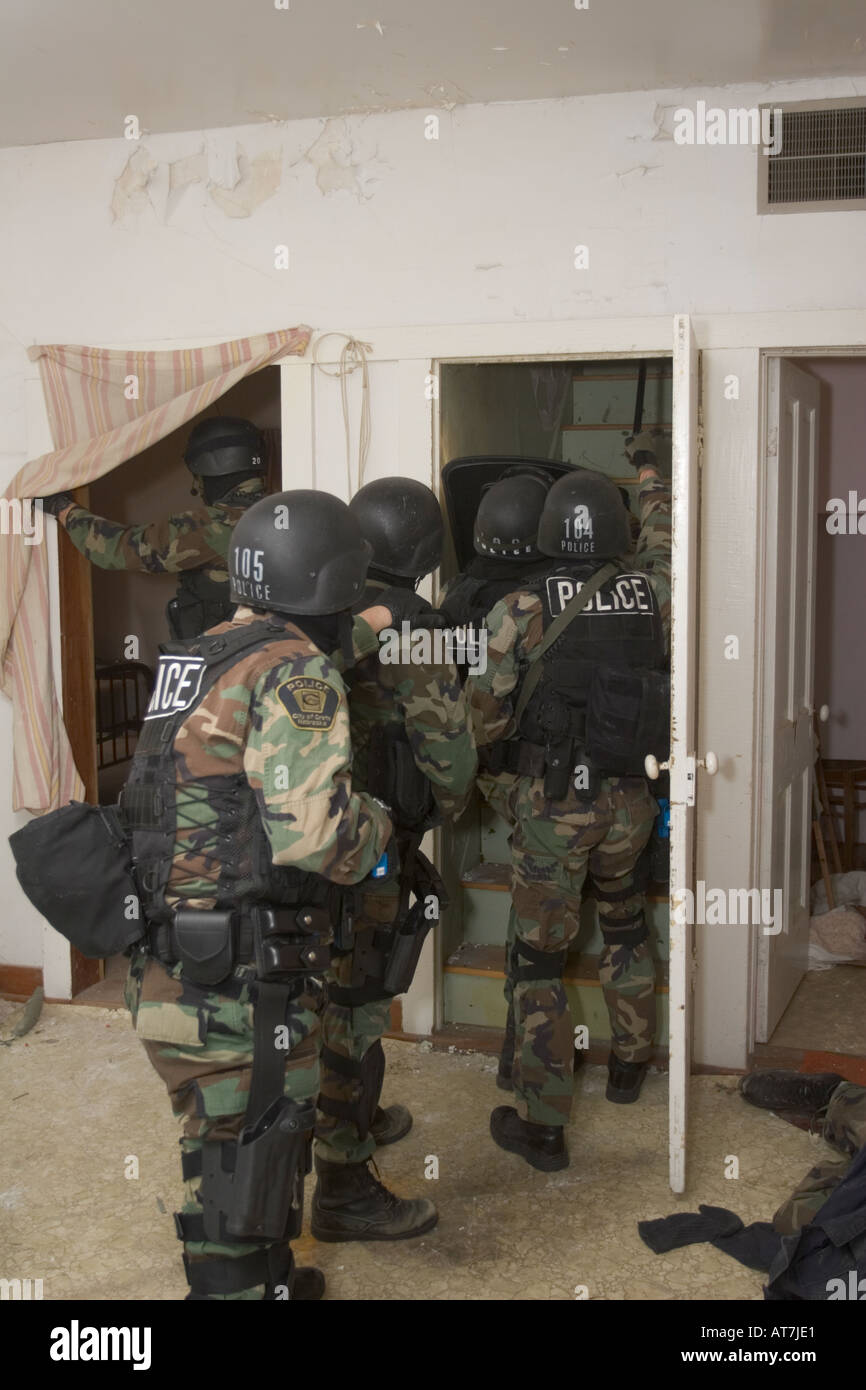 SWAT team as they enter house to serve a search warrant. Team securing ...