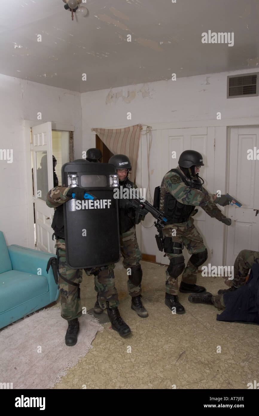 SWAT team as they enter house to serve a search warrant. Point man ...