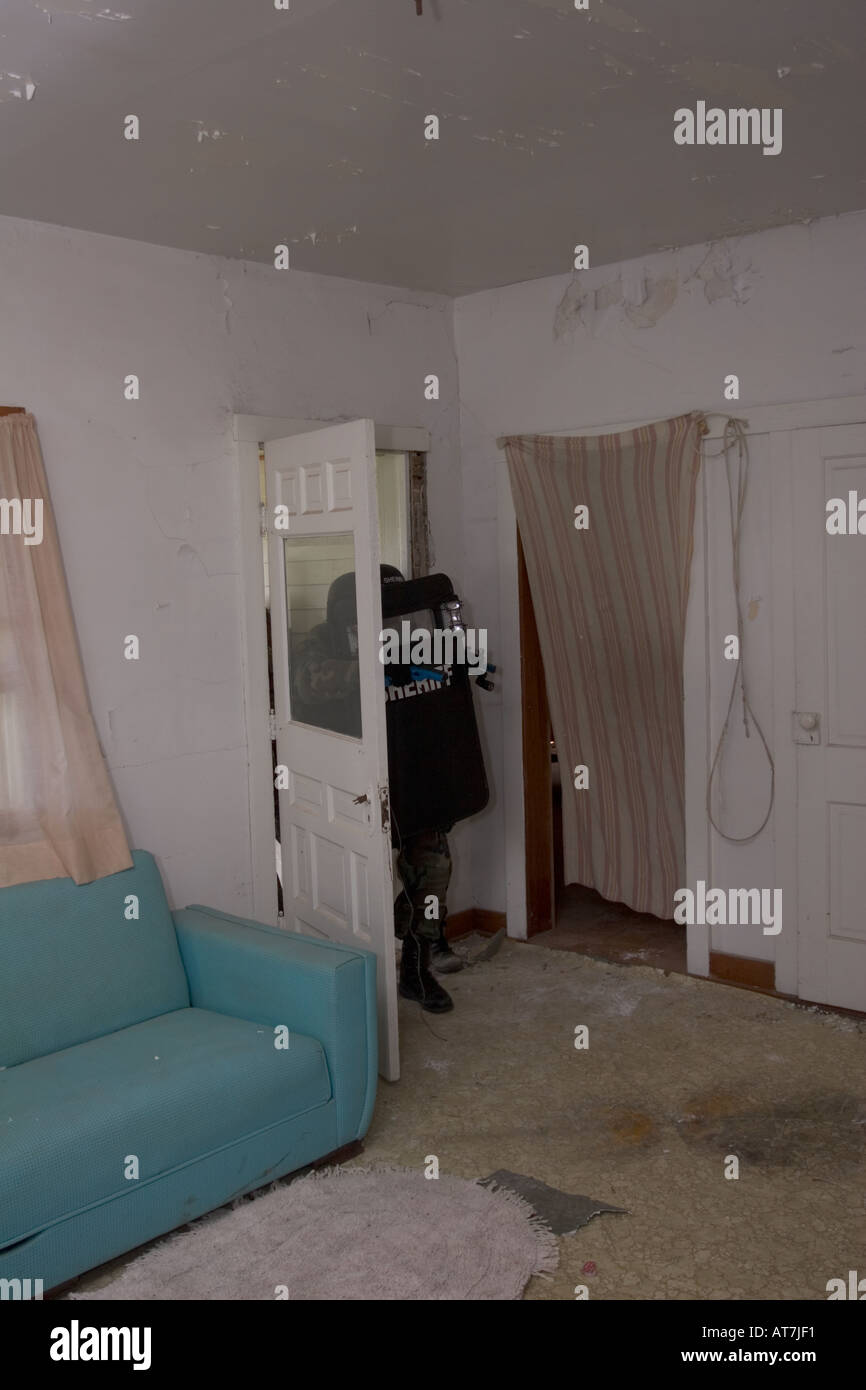 SWAT team as they enter house to serve a search warrant. Point man ...