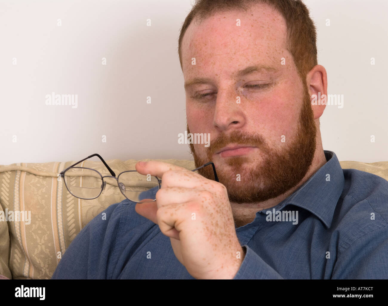 young man straining eyes after removing glasses Stock Photo - Alamy