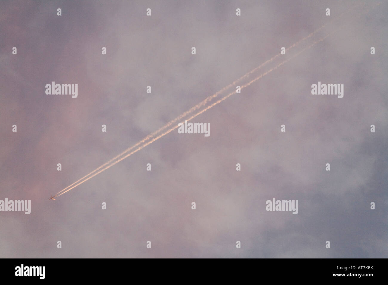 Jet and sky vapour trail through clouds just before sunset Stock Photo ...