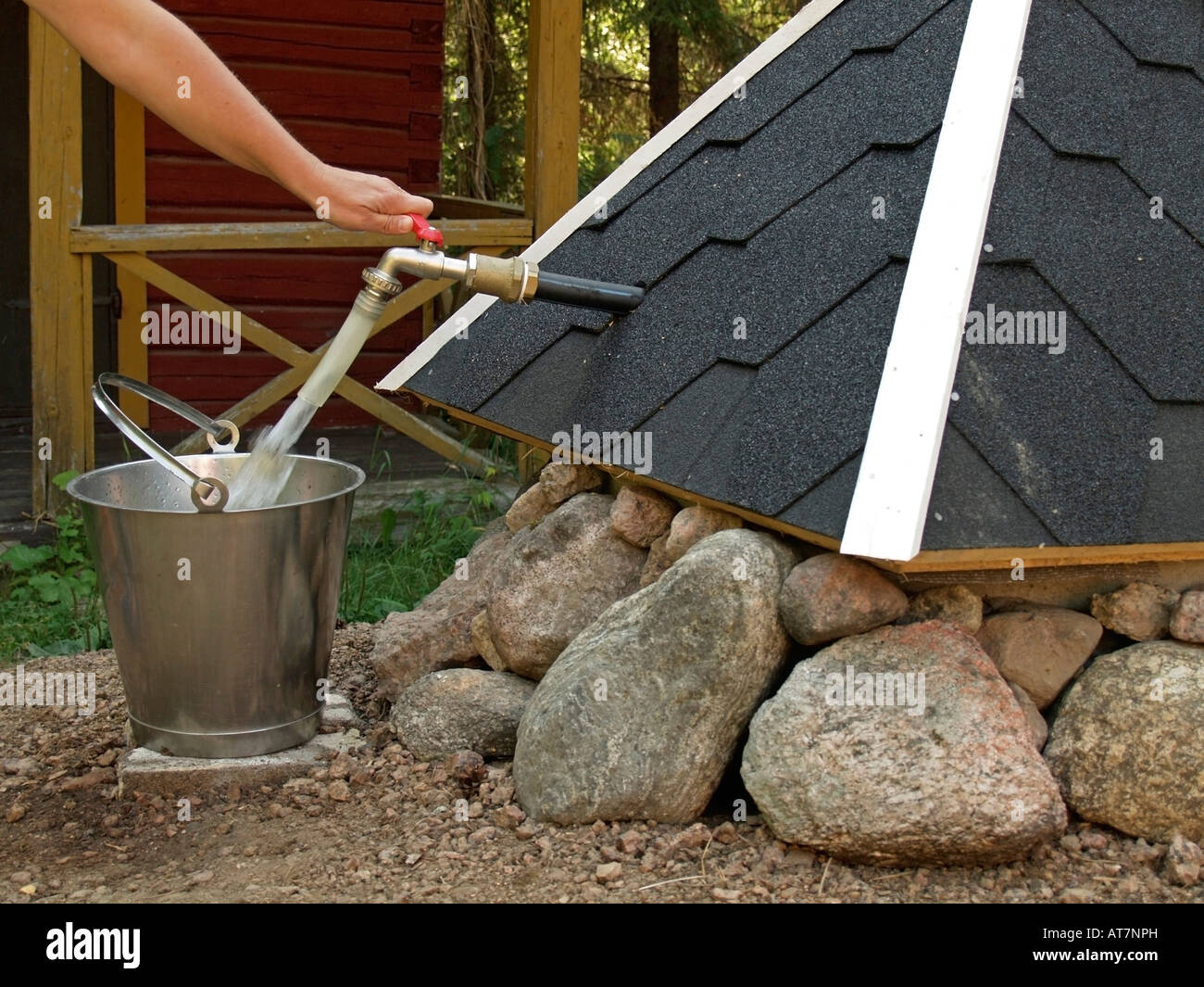 hand tapping drinking water from a well water running from tap into a ...