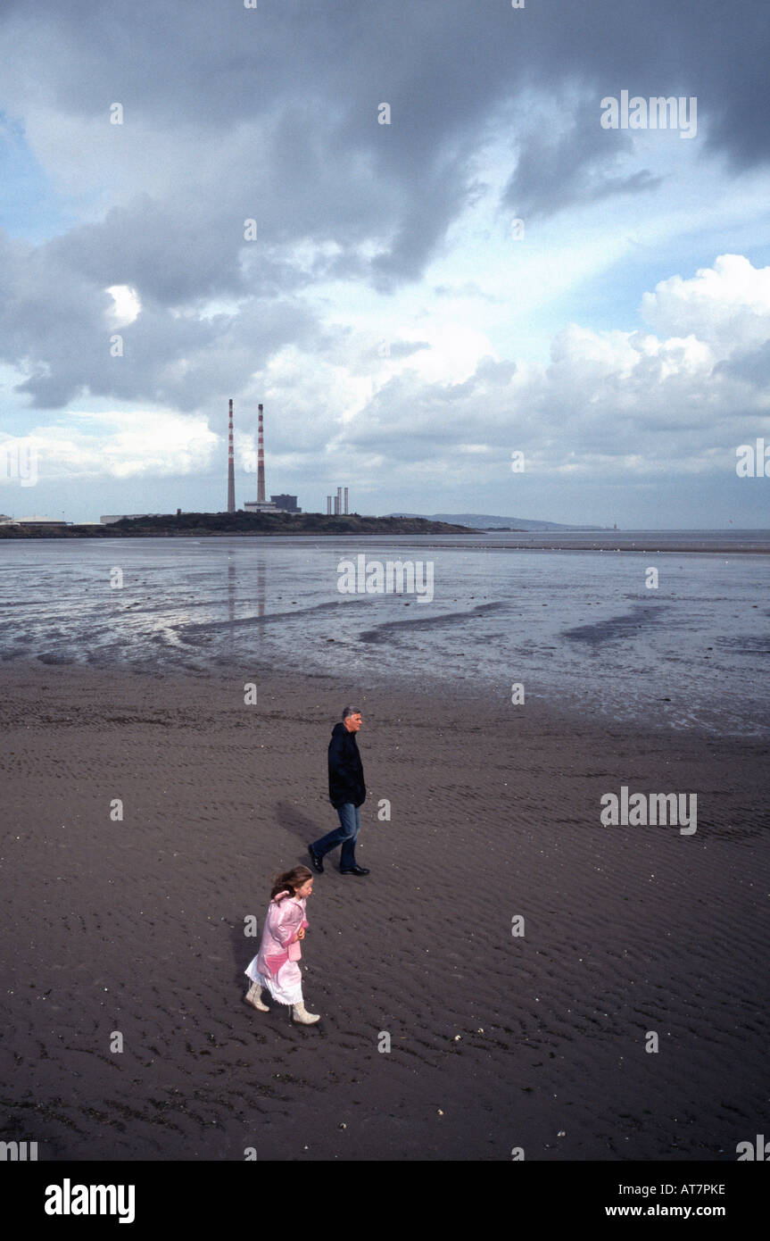 adult and young girl walking on Sandymount Strand, Dublin Bay, Ireland ...