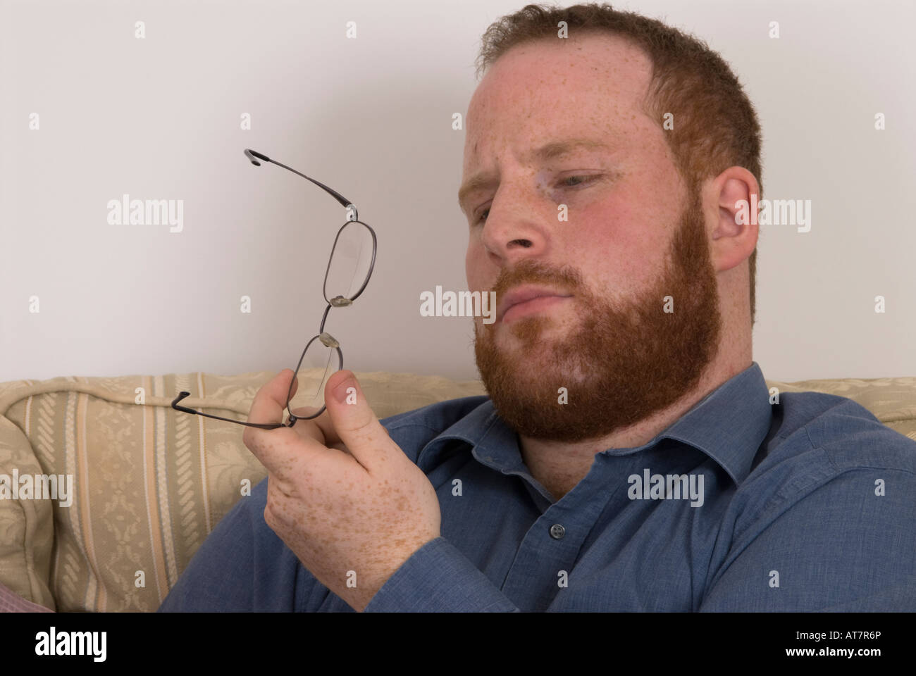 young man straining eyes after removing glasses Stock Photo - Alamy