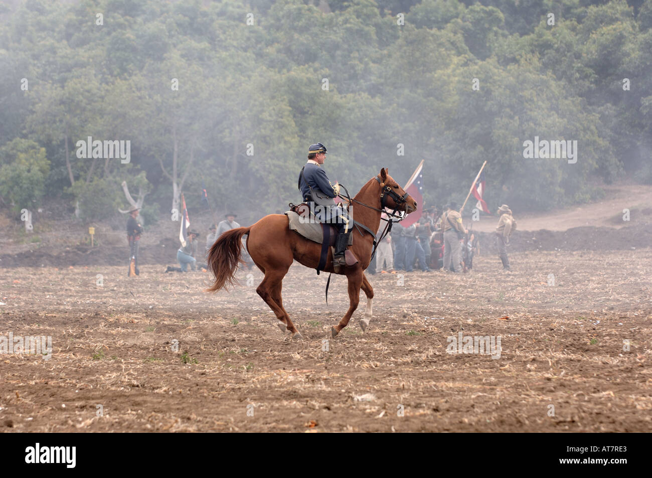 Soldier riding horse in battlefield at Civil War reenactment event ...