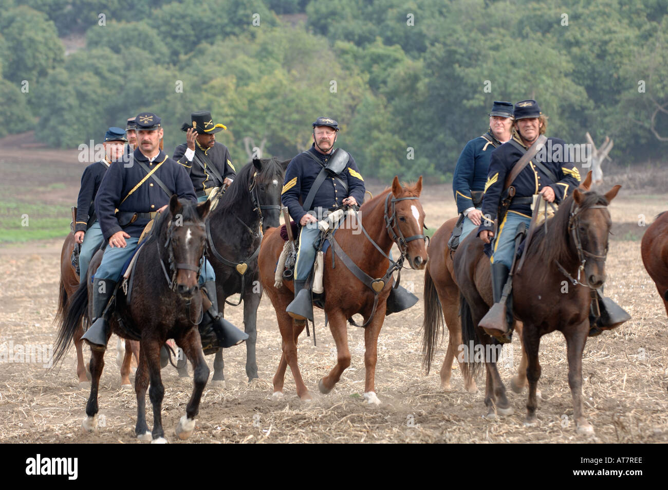 Mounted soldiers riding across smoky battlefield at Civil War ...