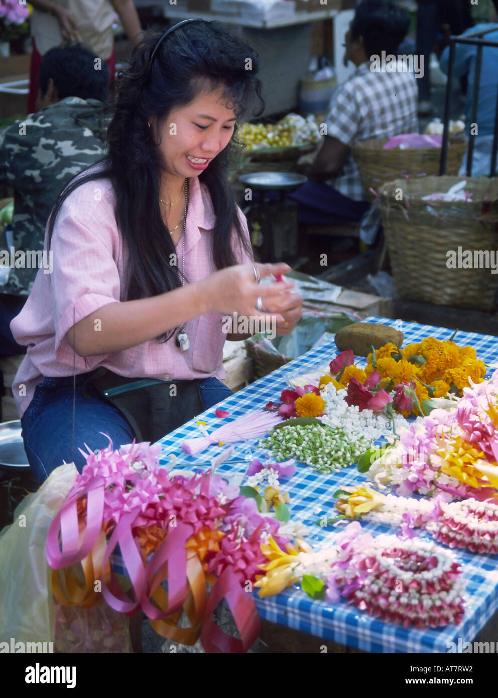 Woman making flower garlands hi-res stock photography and images - Alamy