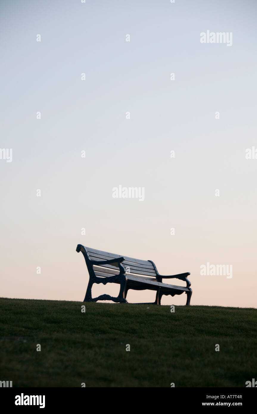 empty park bench at dusk twilight silhoueted against the twilight ...