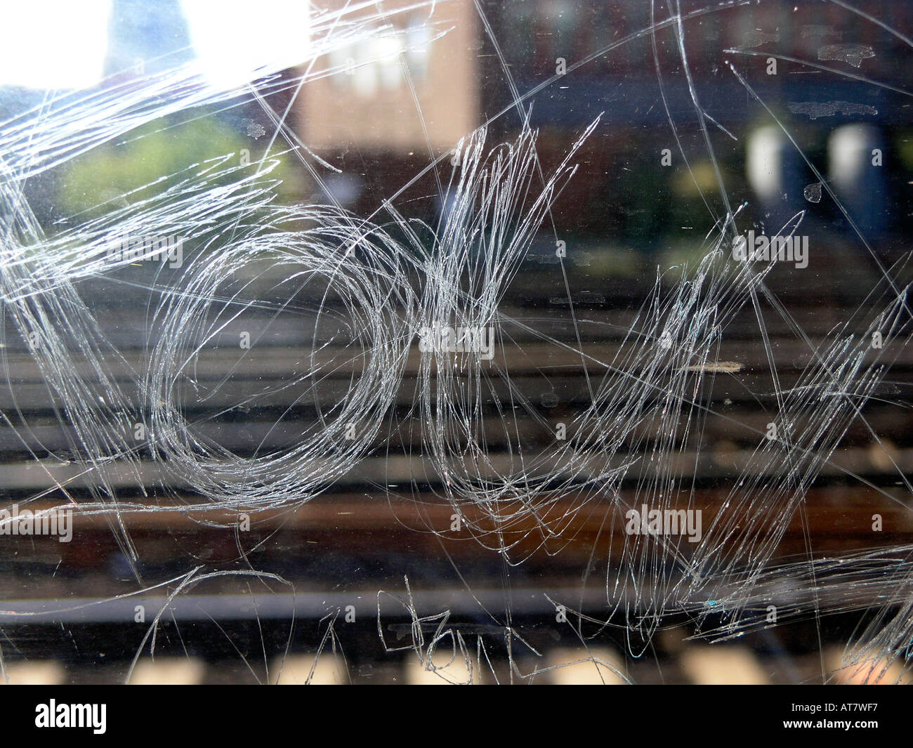Railway carriage window with graffiti scratched onto it London England ...