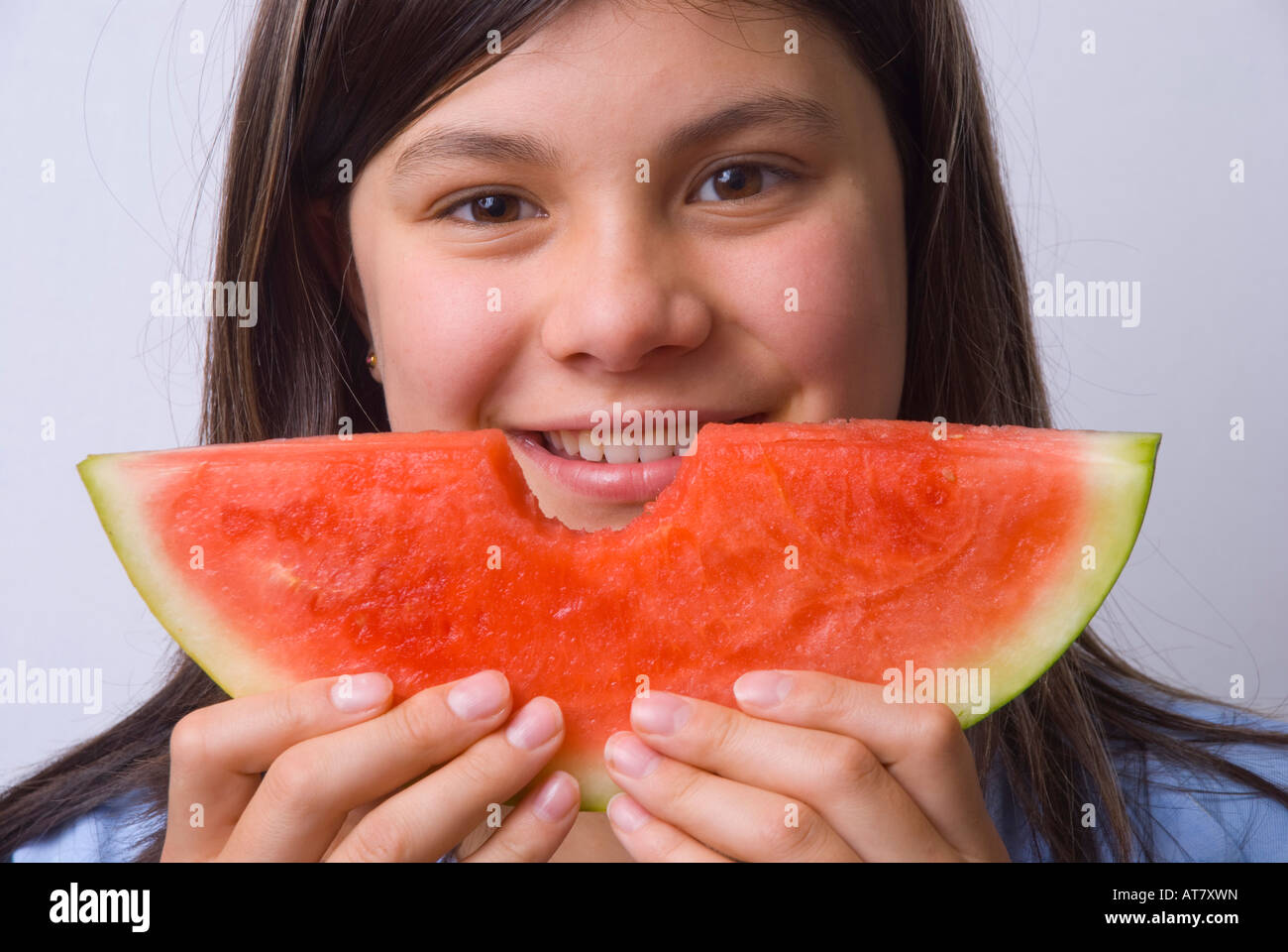 Smiling young girl eating a slice of ripe seedless watermelon Stock ...