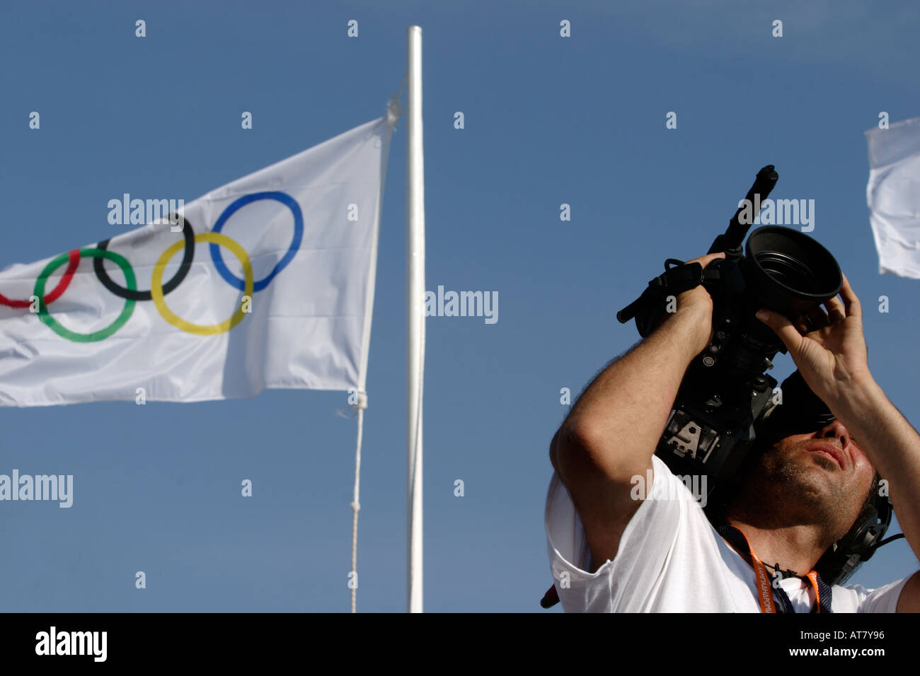 Cameraman shooting by the Olympic Flag Stock Photo - Alamy