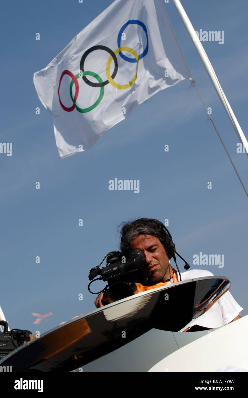 Cameraman shooting the Olympic Flame by the Olympic Flag Stock Photo ...