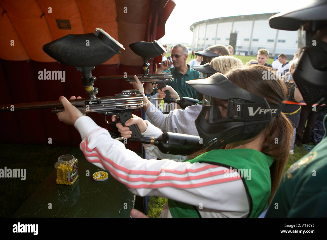 Teenage girl taking part in a paintballing target shooting competition ...