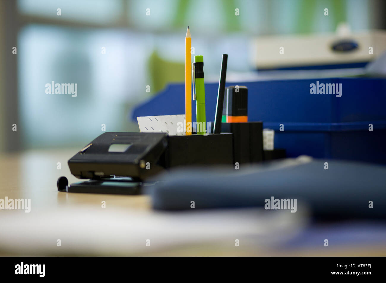detail of a an office desk wit a perforator and a pencil holder Stock ...