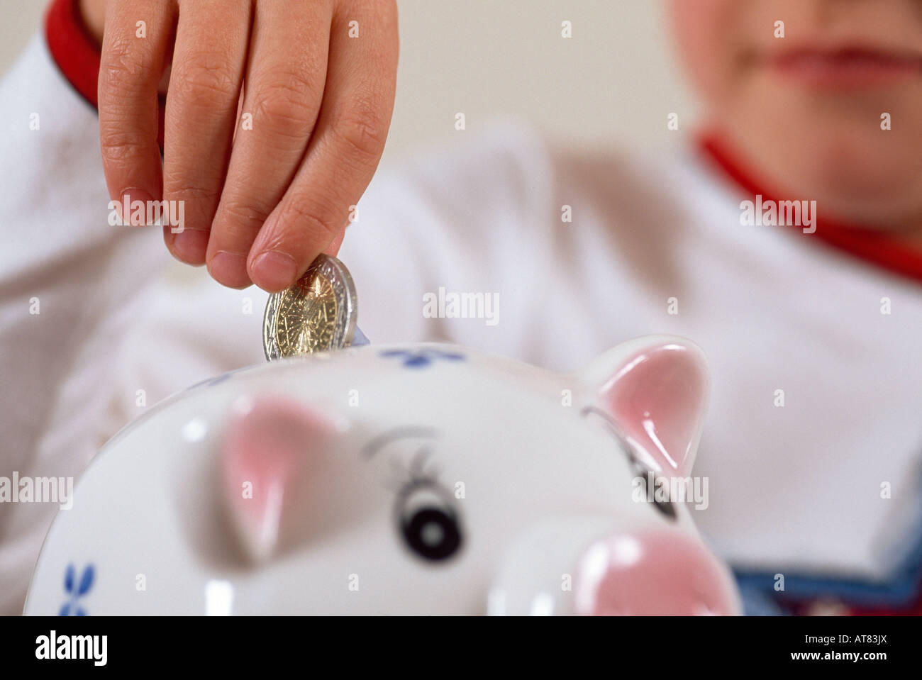 Coins in piggy bank hi-res stock photography and images - Alamy