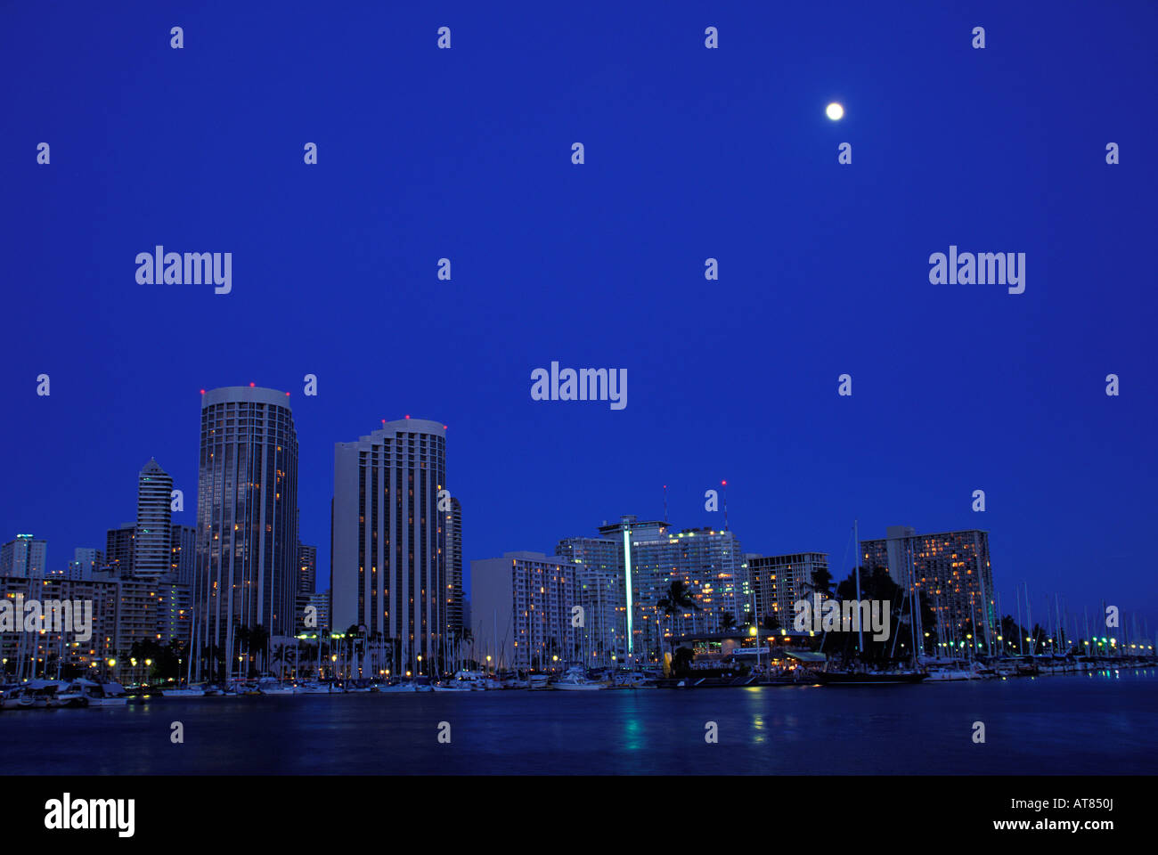 Honolulu at night with the moon Stock Photo - Alamy