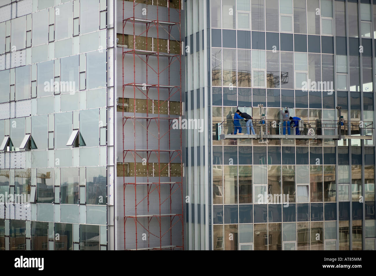 constructors installing new windows for an office building Stock Photo ...