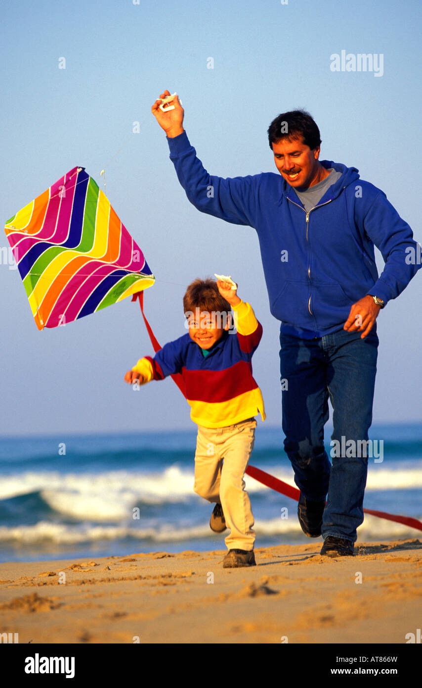 Father and son flying a kite on the beach Stock Photo - Alamy