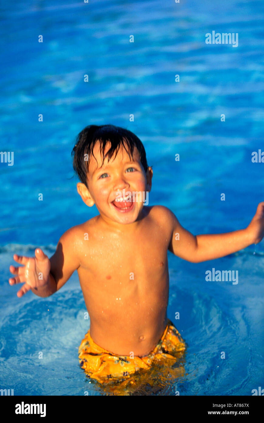 Young boy playing in the pool Stock Photo - Alamy