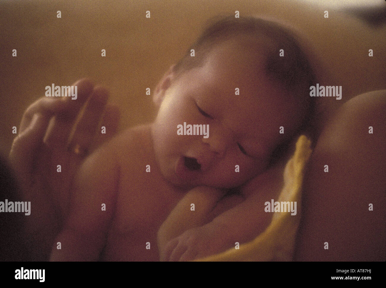 A beautiful newborn baby boy is cradled in his mother's hands Stock ...