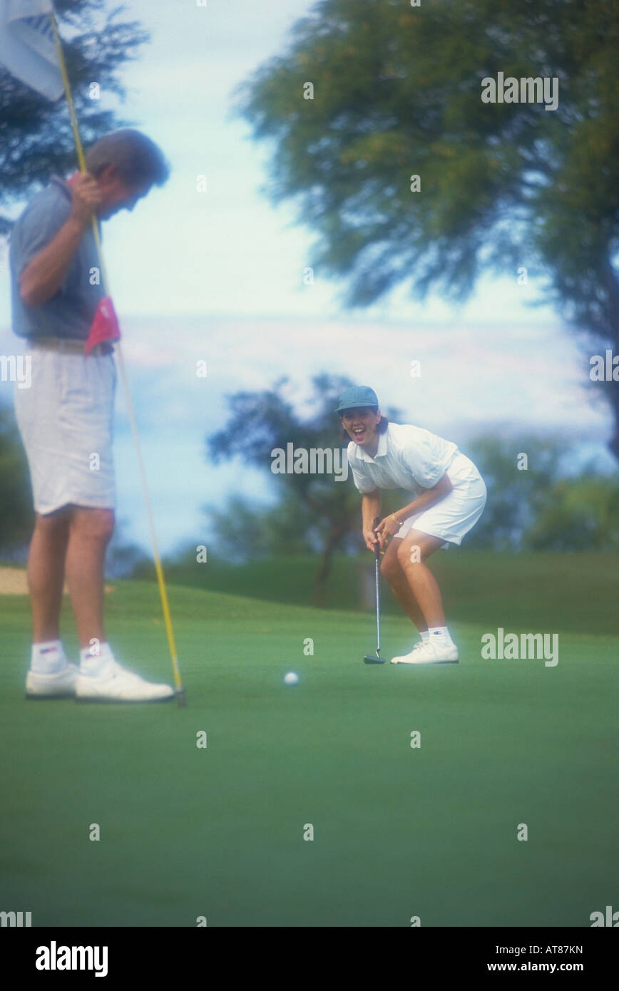Couple playing golf together on Maui Stock Photo - Alamy
