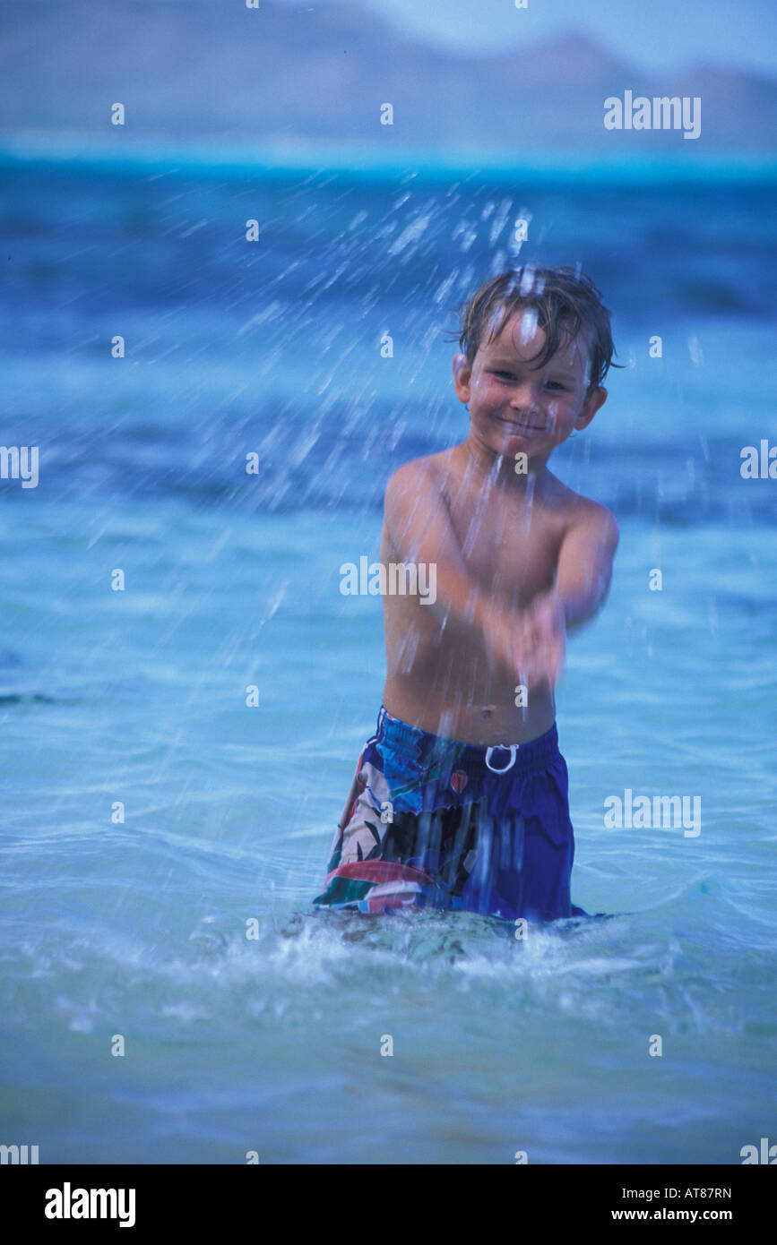 A young boy plays in the clear blue ocean on the windward side of Oahu ...