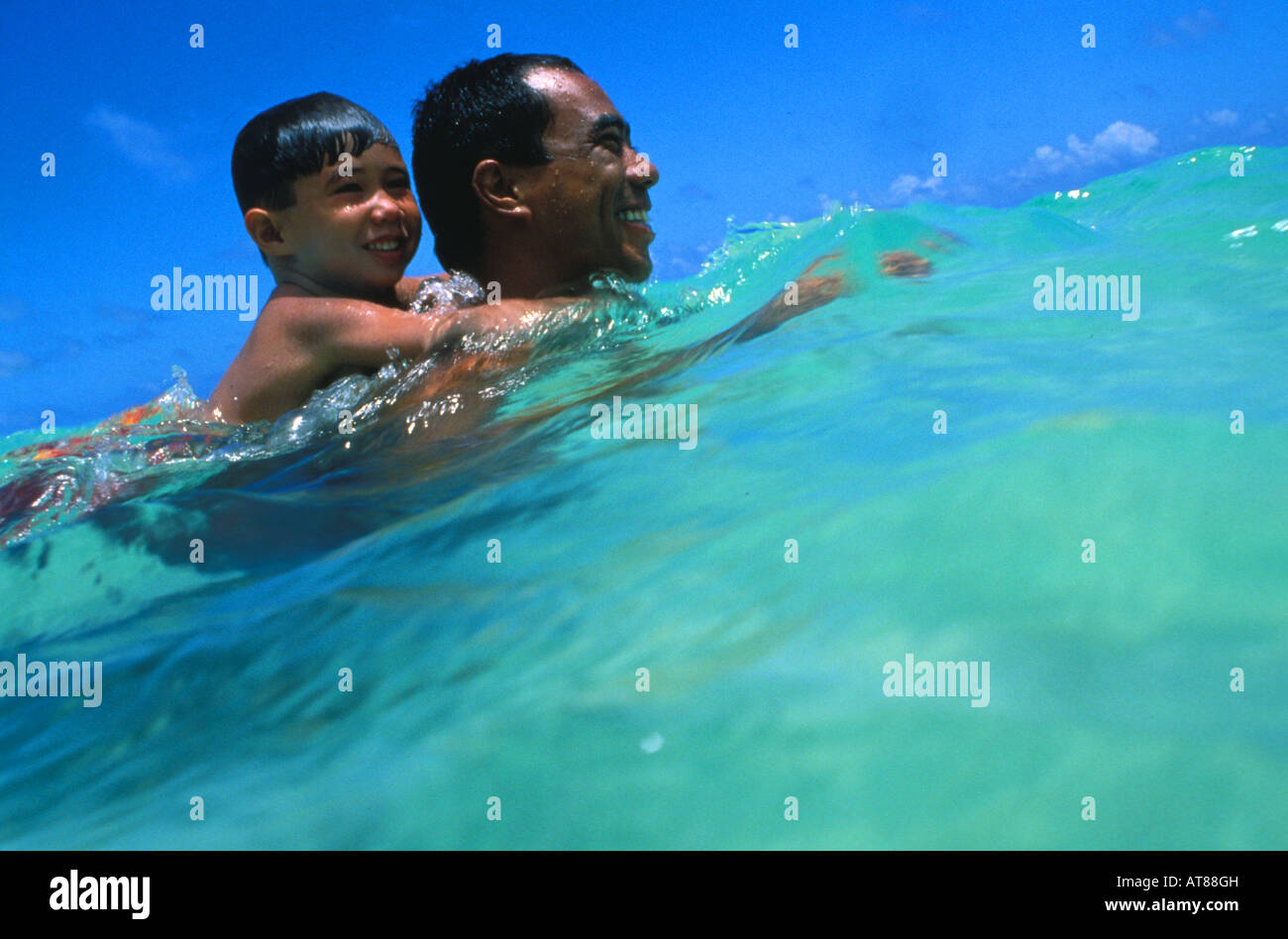 Local father and son playing in ocean, Windward Oahu Stock Photo - Alamy