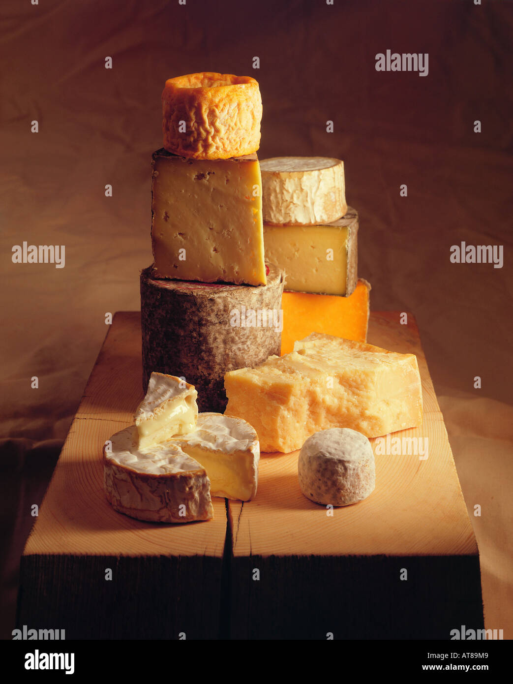 Selection of cheeses on a wooden block Stock Photo - Alamy