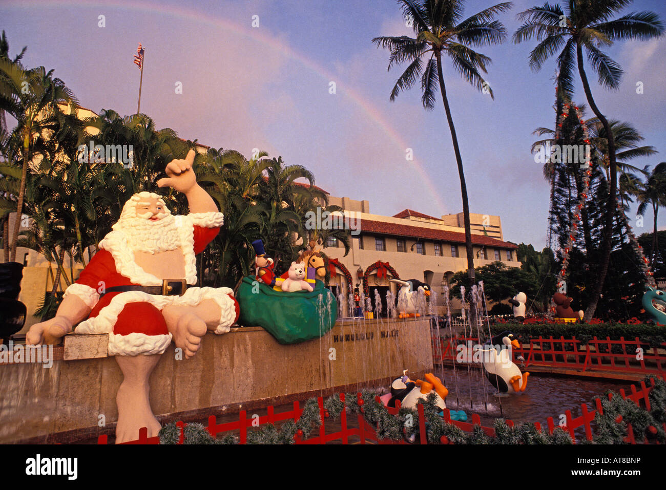 Large Santa Claus flashing the shaka sign sitting on the wall outside ...
