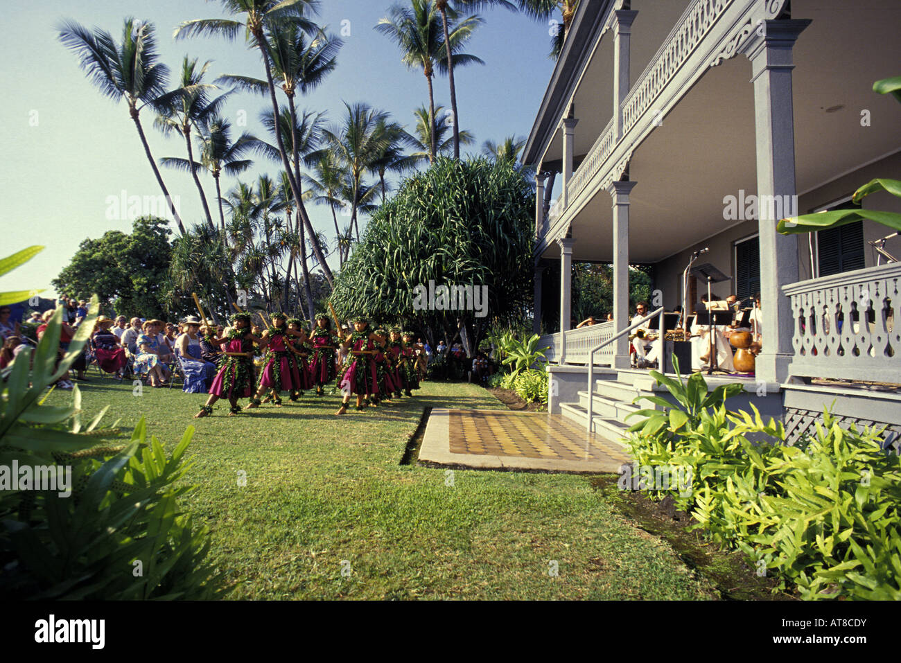 Female halau wearing traditional costumes and maile lei perform hula ...