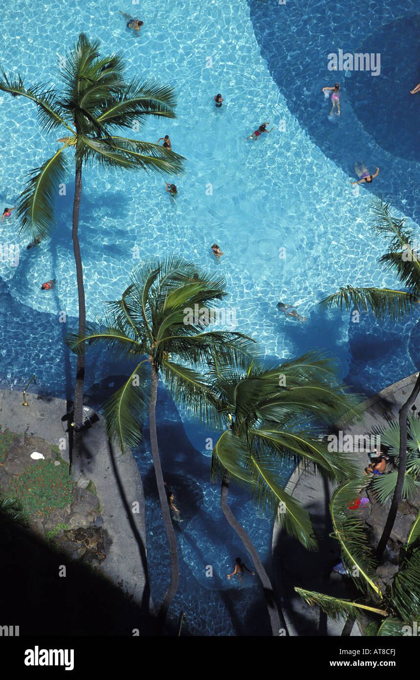 Tourists sunbathe and swim at the Hilton Hawaiian Village's luxurious ...