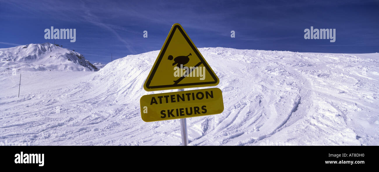 Attention skiers yellow triangular sign in the French alps with ski ...