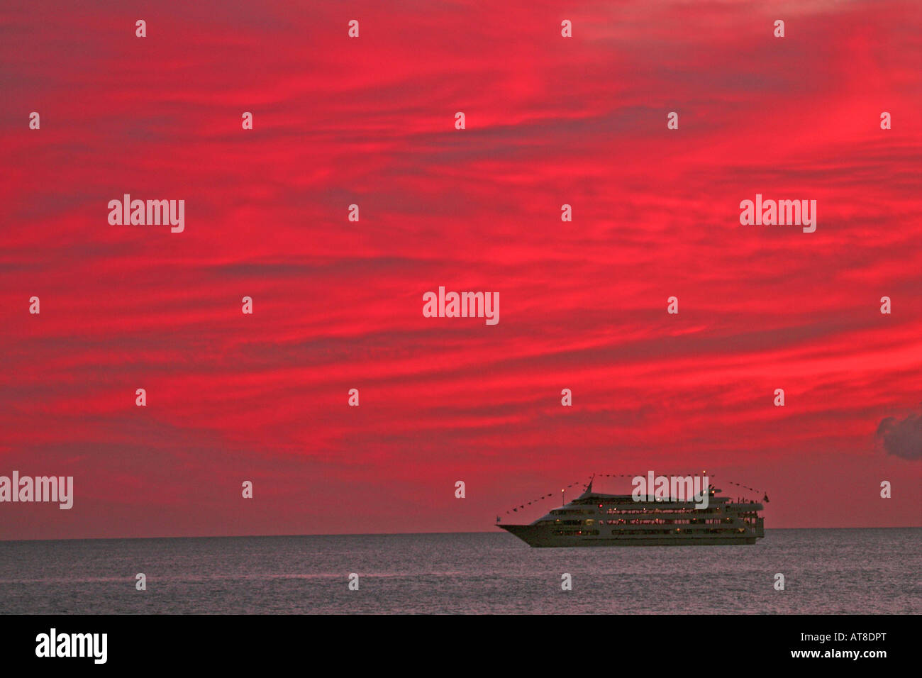 Cruise ship with bright red clouds from sunset off Honolulu Stock Photo ...