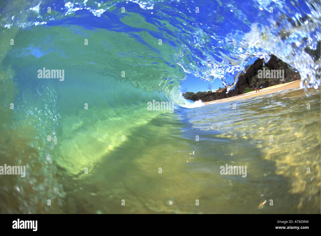 Clean, clear small wave with sandy bottom and blue skies to enhance ...