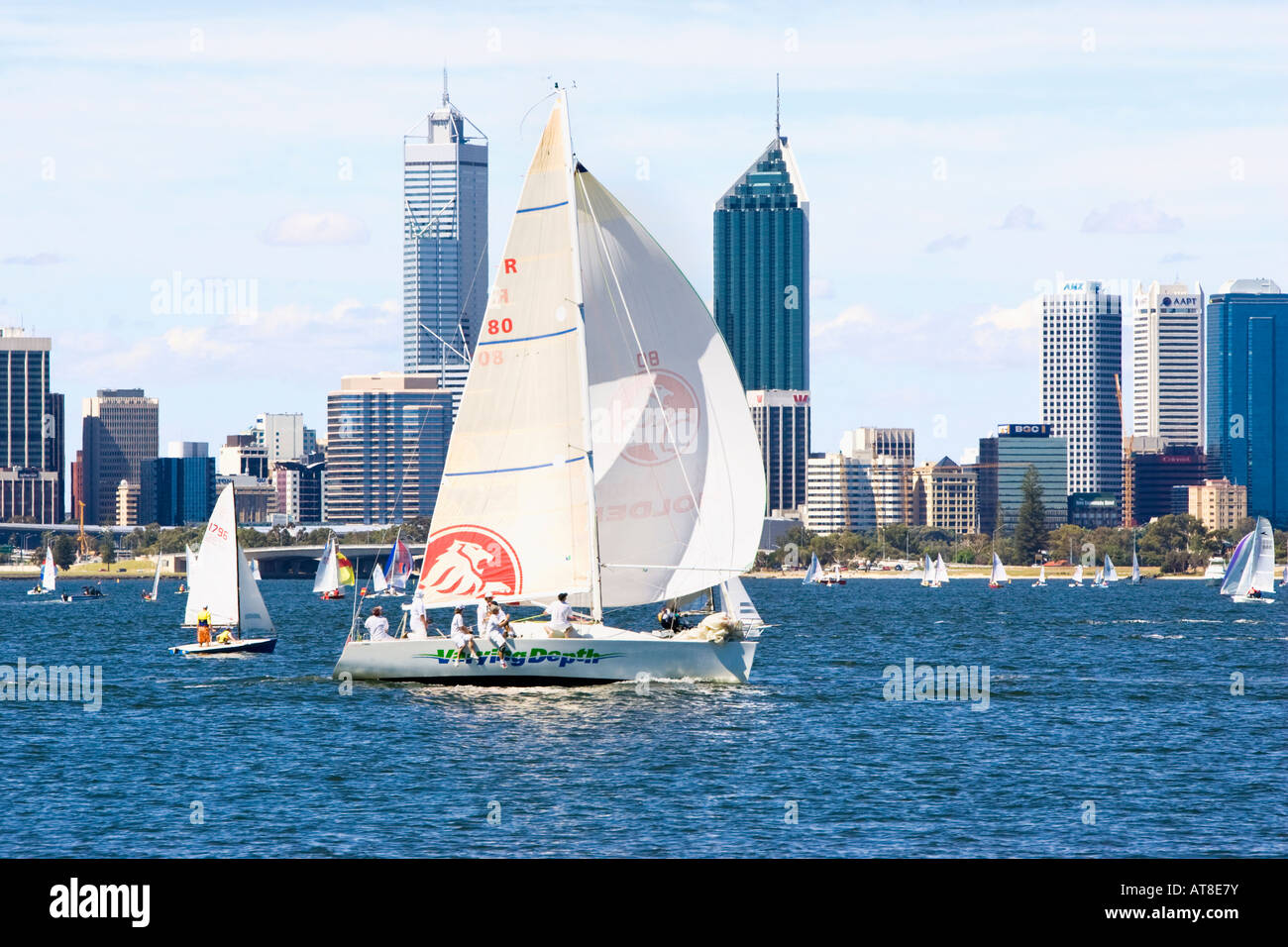 Yachts sailing on the Swan River with Perth's skyscrapers in the ...
