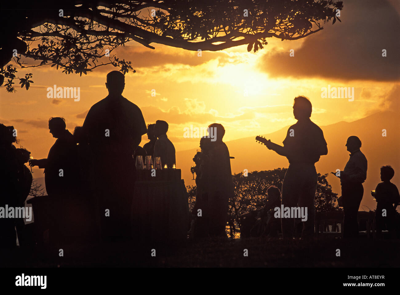 Sunset reception at Kapalua Bay, Maui with crowds of people silhouetted ...