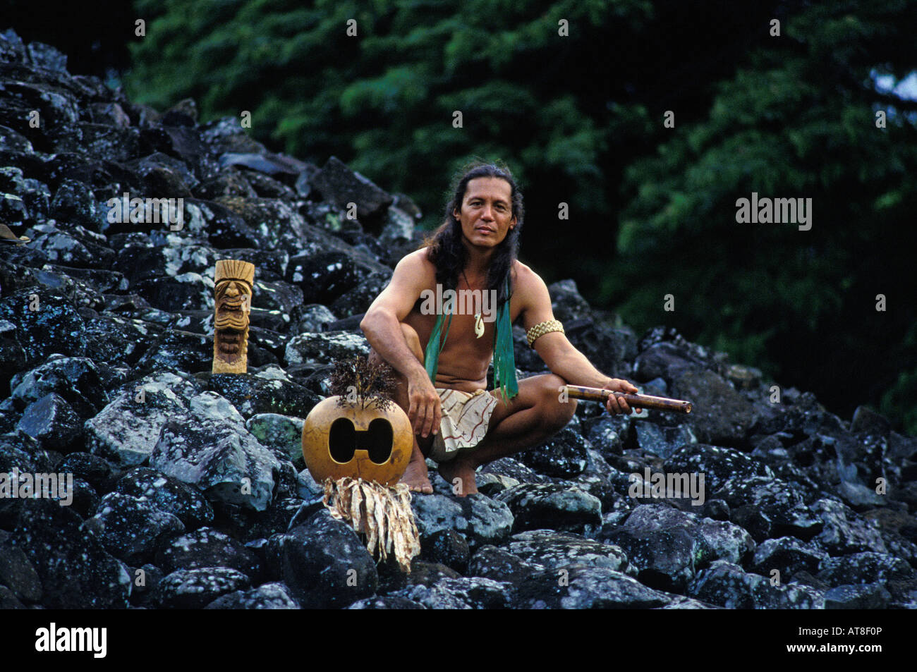 Hawaiian man with native flute and mask at Ulupo temple heiau, Oahu ...