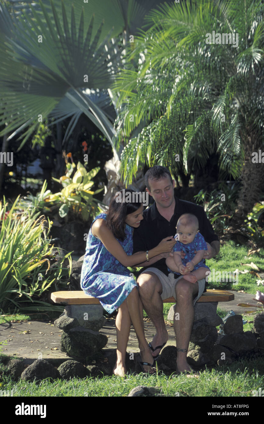Couple and baby in tropical garden hi-res stock photography and images ...