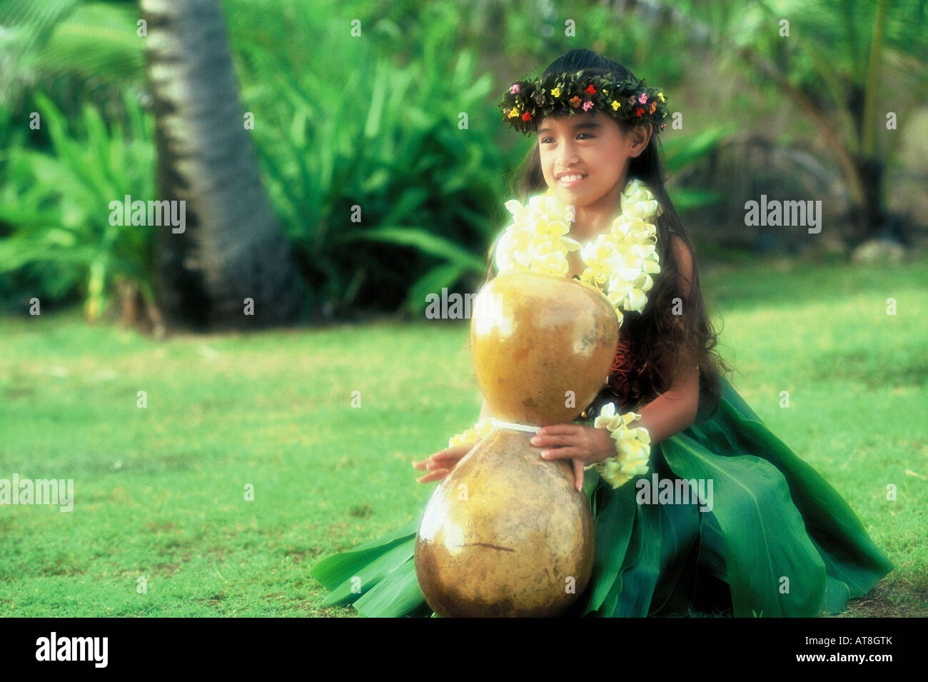 Beautiful young Hawaiian girl (age 7) with ipu heke (gourd) plumeria ...