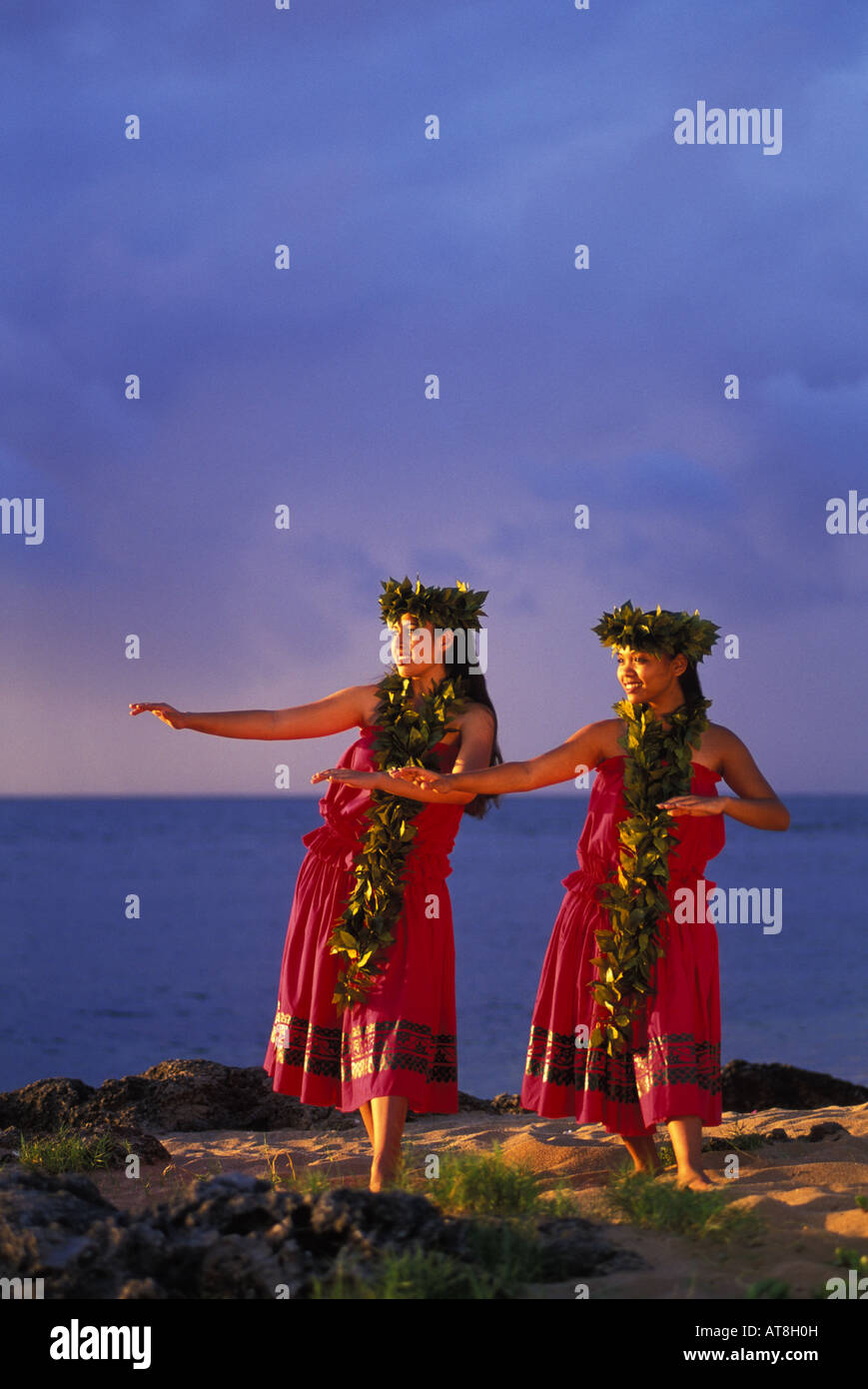 Two young women dancing kahiko (ancient) hula wearing maile leis near ...