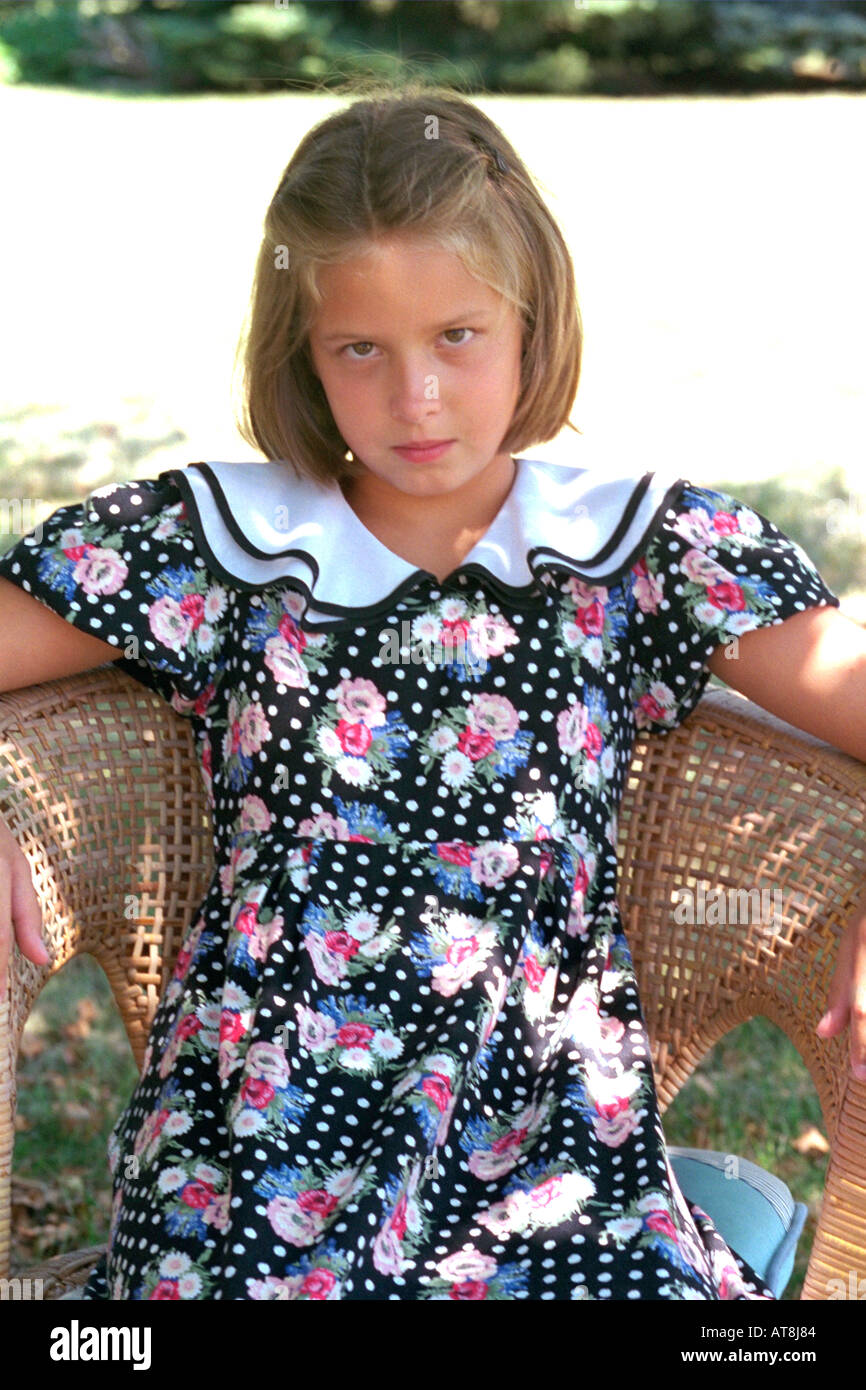 Girl age 9 dressed up and sitting in a wicker chair with attitude ...
