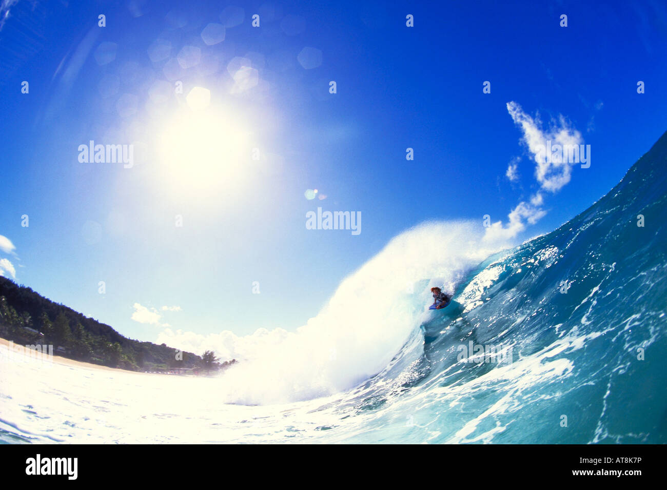 Bodyboarding off the wall of a large wave on the north shore of Oahu ...