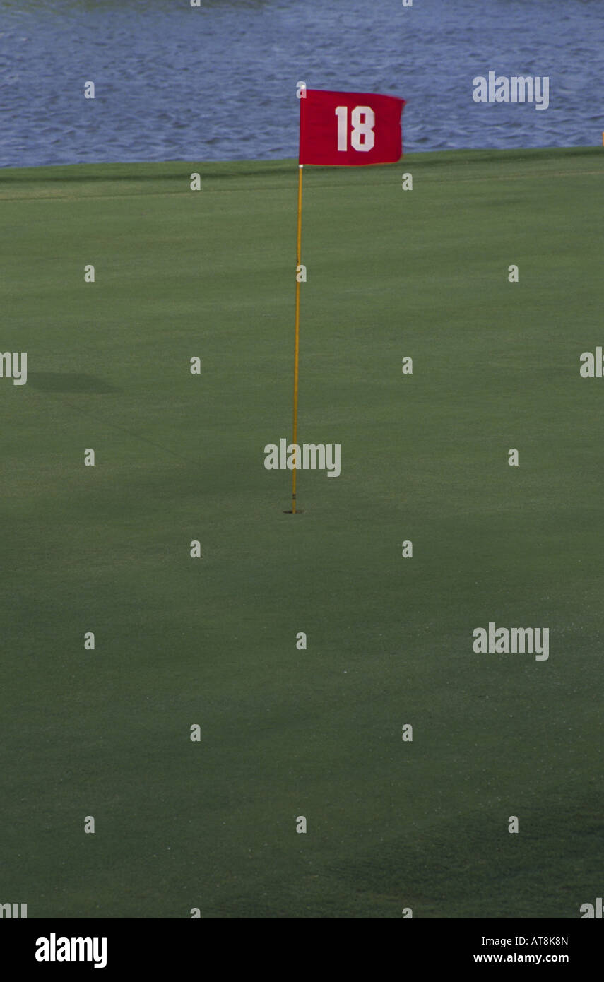 The red flag of the 18th hole on a Big Island golf course Stock Photo ...