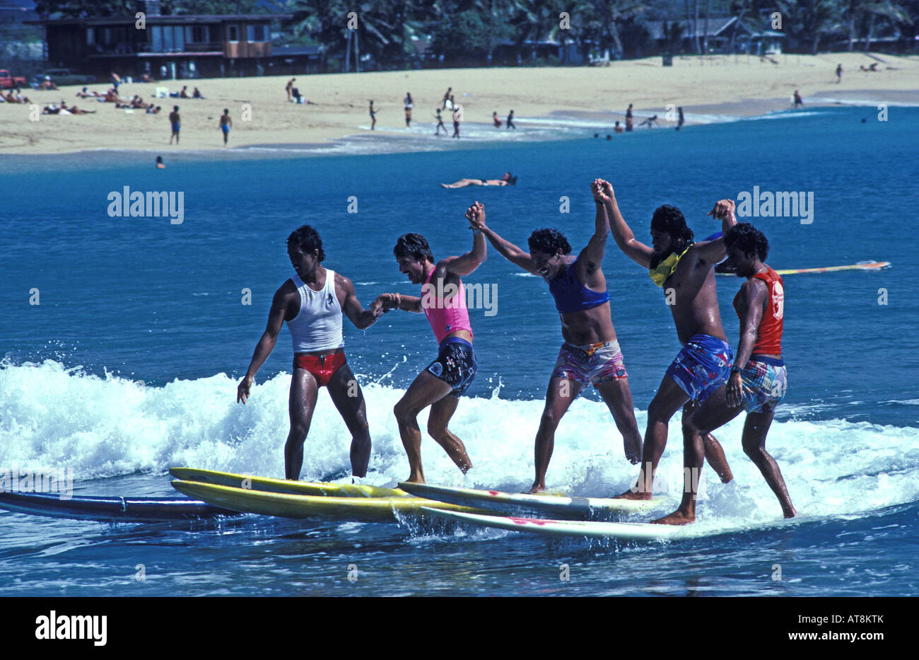 EDITORIAL ONLY. Young men surfing as a group Stock Photo - Alamy