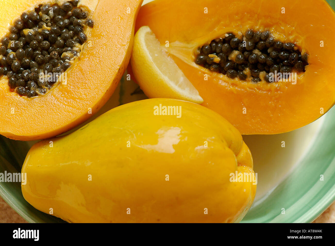 Plate of ripe papaya fruit with lemon wedge Stock Photo - Alamy