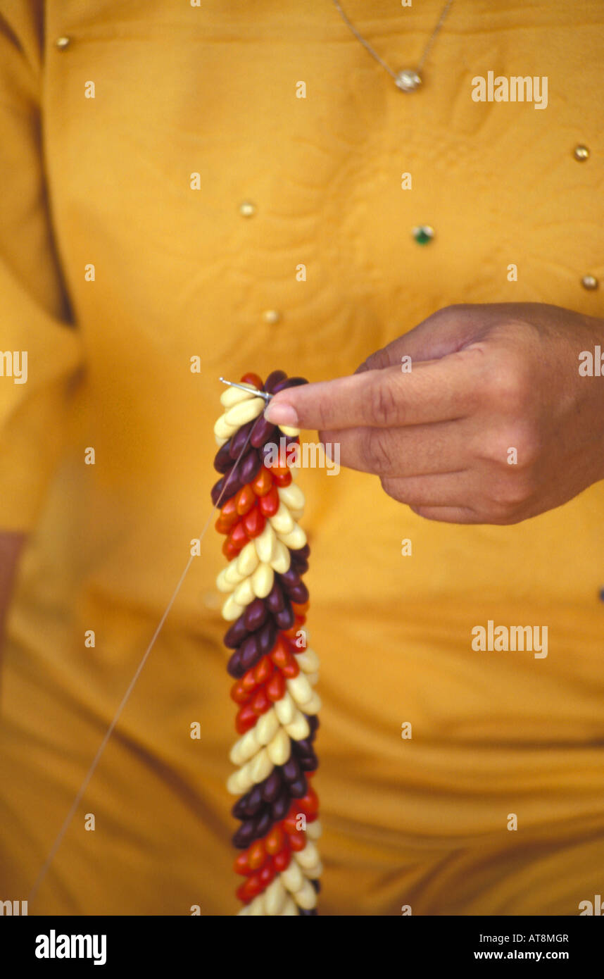 Making a seed lei Stock Photo - Alamy