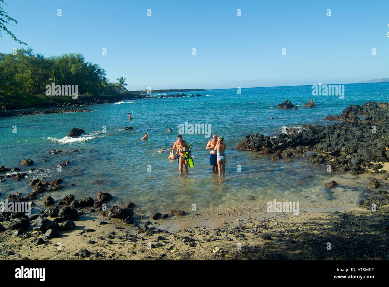 Tourists enjoy snorkeling in the shallow coral beds at Ahihi Bay on the ...