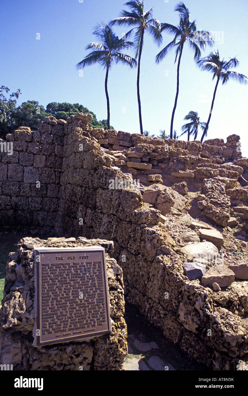 The stone ruins of "The Old Fort" in Lahaina with tall palm trees in ...